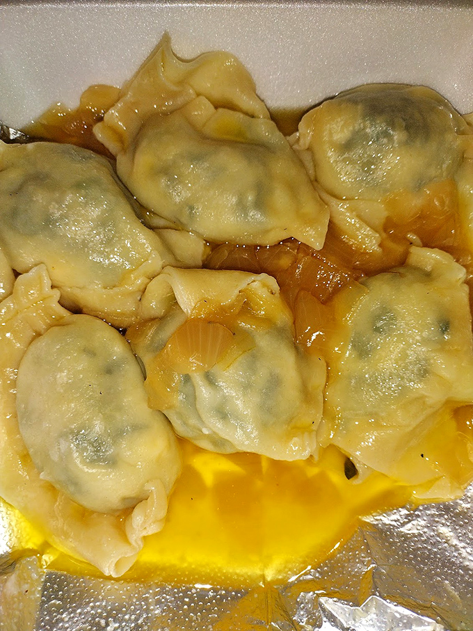 These plump, tender pierogies aren't just food—they're edible pillows stuffed with comfort and tradition, glistening with buttery goodness.