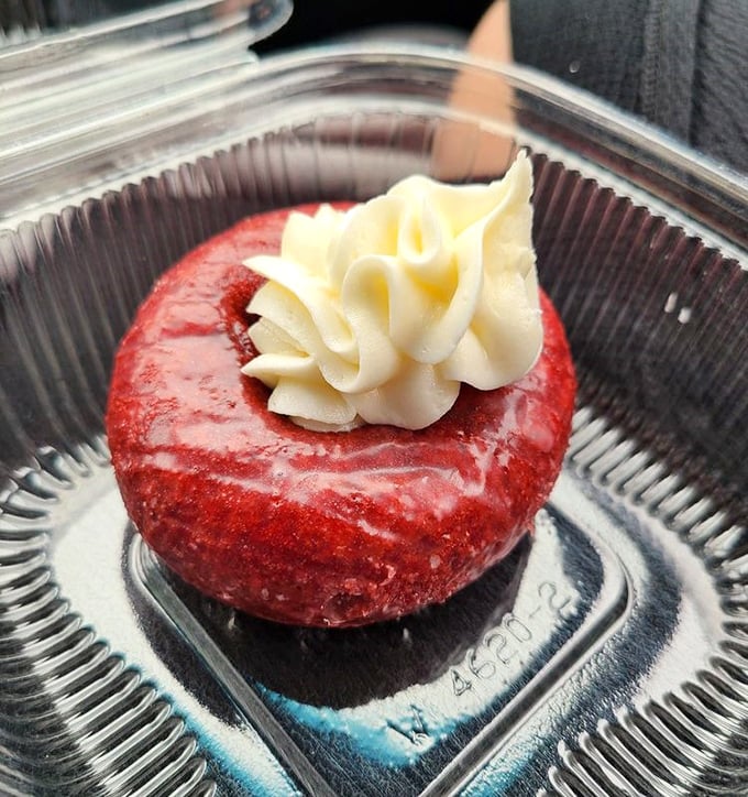 Red velvet donut with cream cheese frosting – proving that formal wear looks good on donuts too.