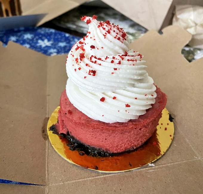 This red velvet cheesecake topped with a cloud of white frosting isn't just dessert—it's what dreams are made of.