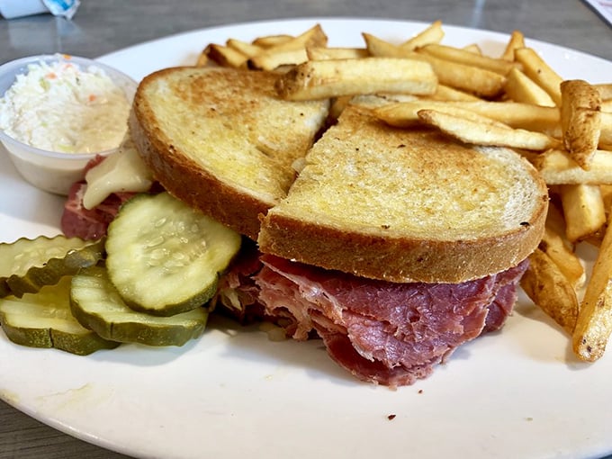 A classic Reuben sandwich that towers with corned beef and sauerkraut—the kind that requires both hands and several napkins to properly enjoy.
