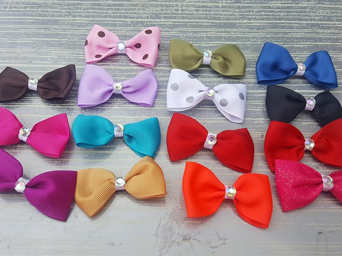 Hair bow diplomacy in action—where every color and pattern stands ready to transform an ordinary ponytail into a statement of personal style.