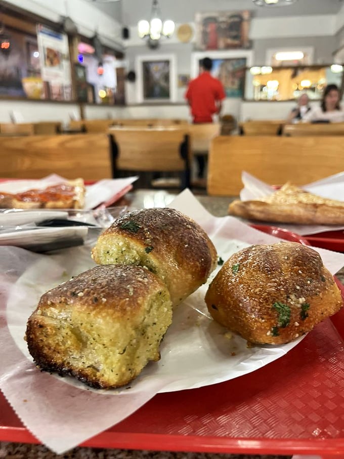 Garlic knots that could make a vampire reconsider his dietary restrictions—golden, glistening, and worth every bit of the subsequent breath mint. 