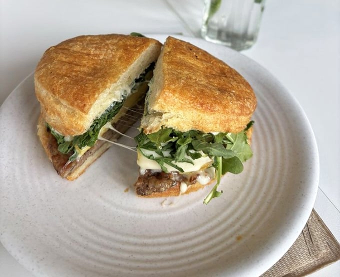 This sandwich has that "I can't believe this is breakfast" energy – melty cheese stretching dramatically like it's auditioning for a food commercial.