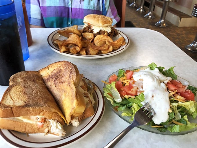 The holy trinity of diner dining: a perfectly grilled sandwich, crispy curly fries, and a side salad to convince yourself you're being somewhat virtuous.