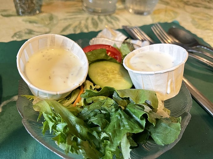The salad course—a crisp prelude to the main event, with house-made dressings that have likely remained unchanged for decades. Some traditions need no updating.