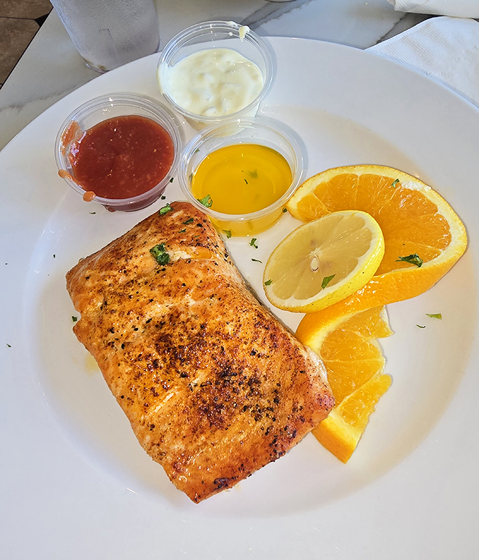This salmon isn't just cooked – it's been treated with the respect a noble fish deserves, served with citrus that brightens every bite.