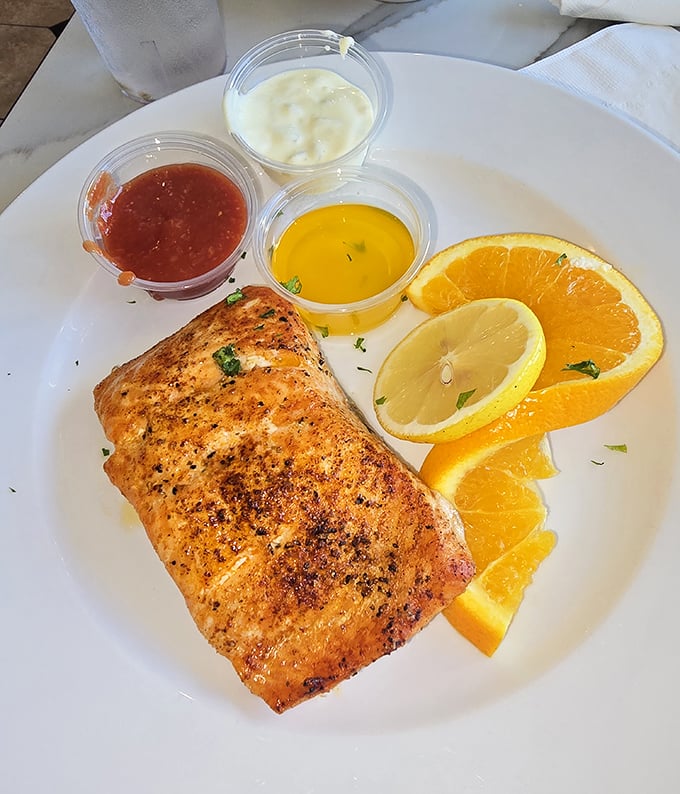 This salmon isn't just cooked – it's been treated with the respect a noble fish deserves, served with citrus that brightens every bite.