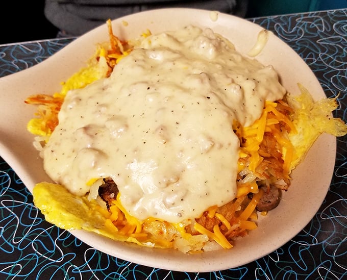 Behold the breakfast bowl—where hash browns, eggs, cheese, and sausage gravy unite in holy matrimony. Morning fuel that could power you through building a barn.