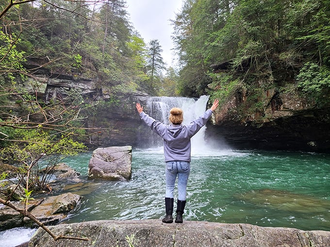 Arms outstretched at Savage Falls—the universal pose of someone who's found their happy place. Water therapy at its most spectacular.