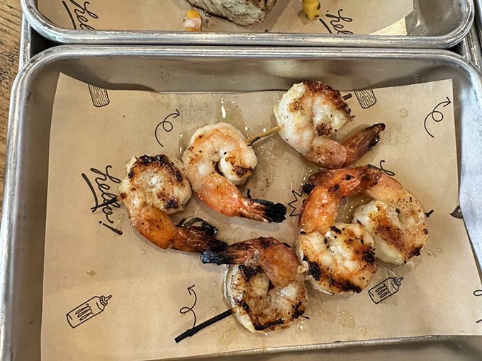 Grilled shrimp skewers prove that seafood deserves smoke too – charred just enough to make you forget you're at a barbecue joint.
