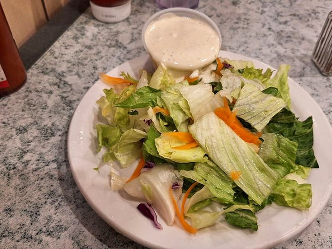 Even the side salad gets respect here—fresh, crisp, and unapologetically simple, like vegetables showing up to a formal event.