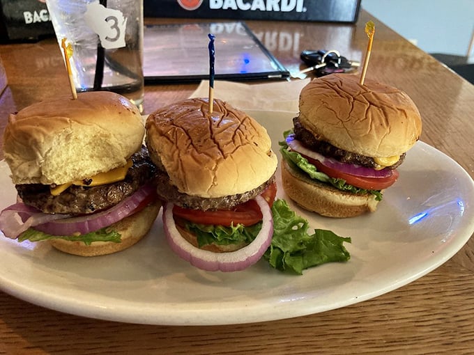 Sliders that prove good things come in small packages – each one a perfect three-bite journey of beef, fresh toppings, and pillowy buns.