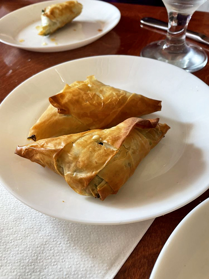 These triangles of phyllo-wrapped goodness aren't just appetizers—they're edible envelopes delivering messages of spinach and cheese directly to your soul.