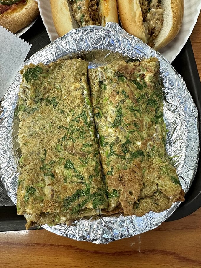 This herb-flecked egg creation might be the unsung hero of the menu, with cheesesteaks lurking in the background.