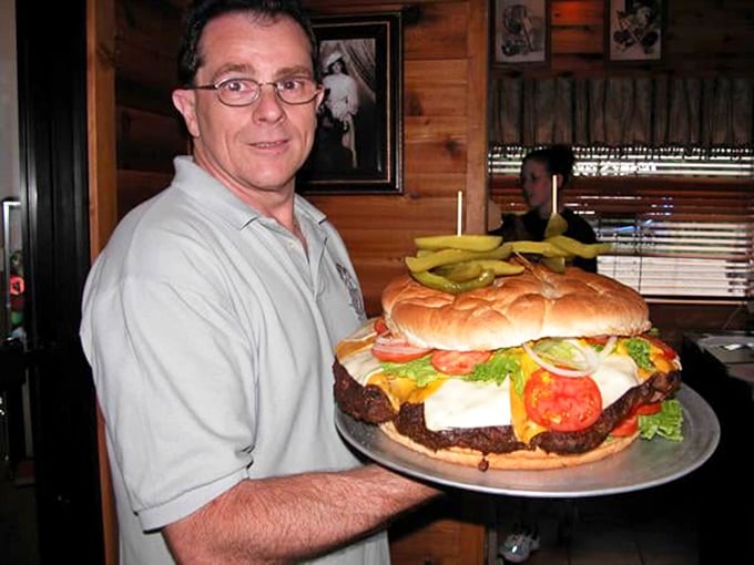 The smile says it all: "Yes, this is a normal-sized burger here." When your server looks this proud, you know you're in for something special.