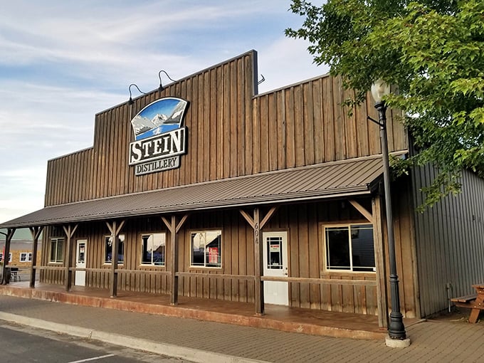 Stein Distillery's western facade promises liquid treasures within. The mountains in their logo? Just a preview of your actual view.