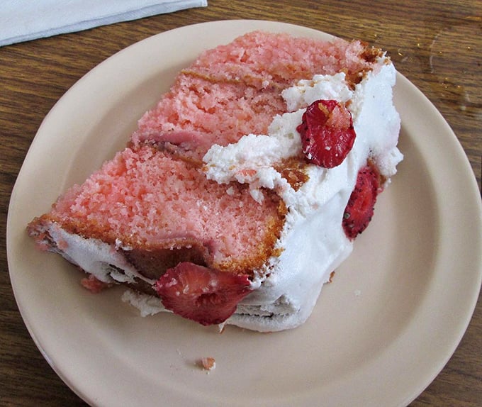 Pink strawberry cake that doesn't just satisfy your sweet tooth—it throws a party for it, complete with fresh berries.