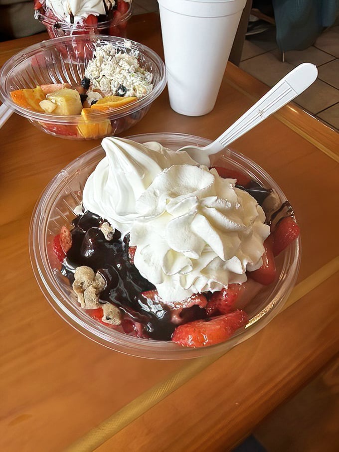 This sundae doesn't just have toppings – it has neighborhoods of whipped cream, hot fudge, and fresh strawberries in perfect, delicious harmony.