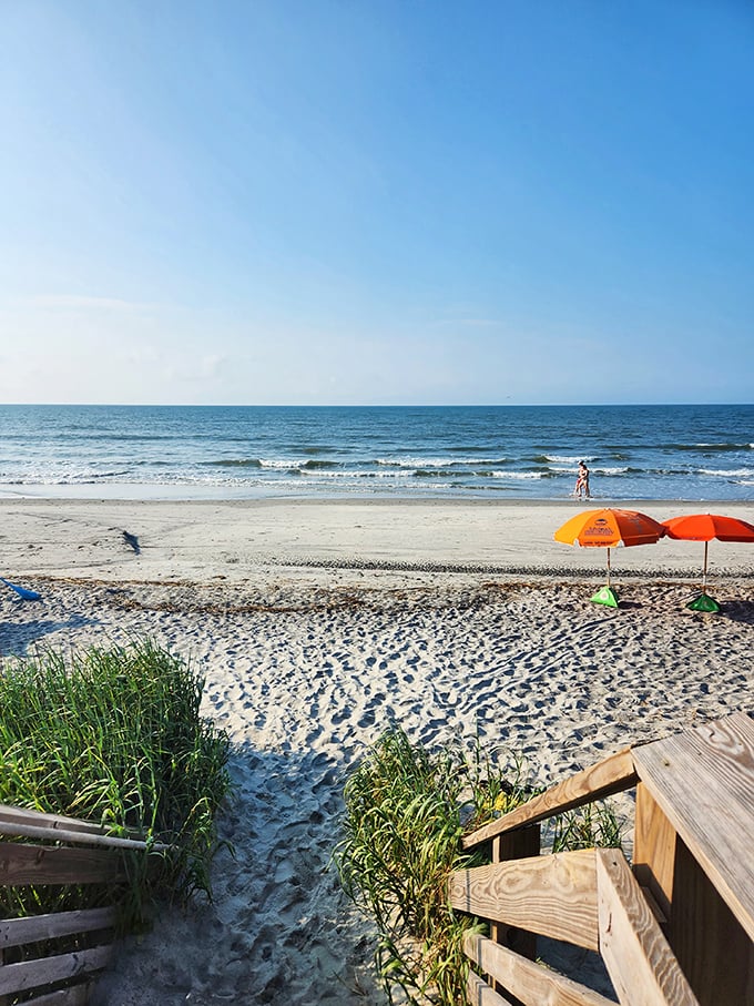 Colorful umbrellas dot pristine sand like confetti – nature's celebration where every day feels like a well-deserved vacation.