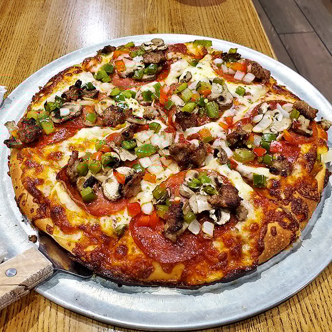A pizza that doesn't just have toppings but wears them like medals of honor – each vegetable and meat precisely placed for maximum flavor impact.