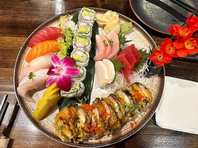 A sushi platter arranged with the care of a jeweler setting precious stones. That purple orchid isn't just garnish—it's a statement.