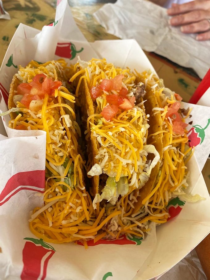 Cheese cascading like a yellow waterfall over seasoned beef. These aren't just tacos—they're edible souvenirs from the heart of Route 66.