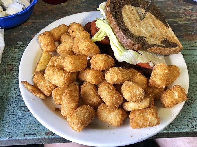 These aren't just any tater tots – they're golden nuggets of potato perfection escorting a sandwich to its delicious destiny.