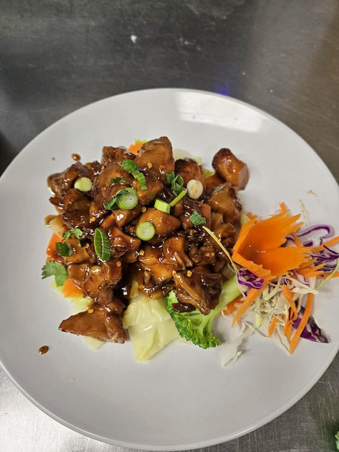 Glistening chunks of meat in a caramelized sauce with that perfect garnish of green onions. This isn't just stir-fry—it's edible art with attitude.