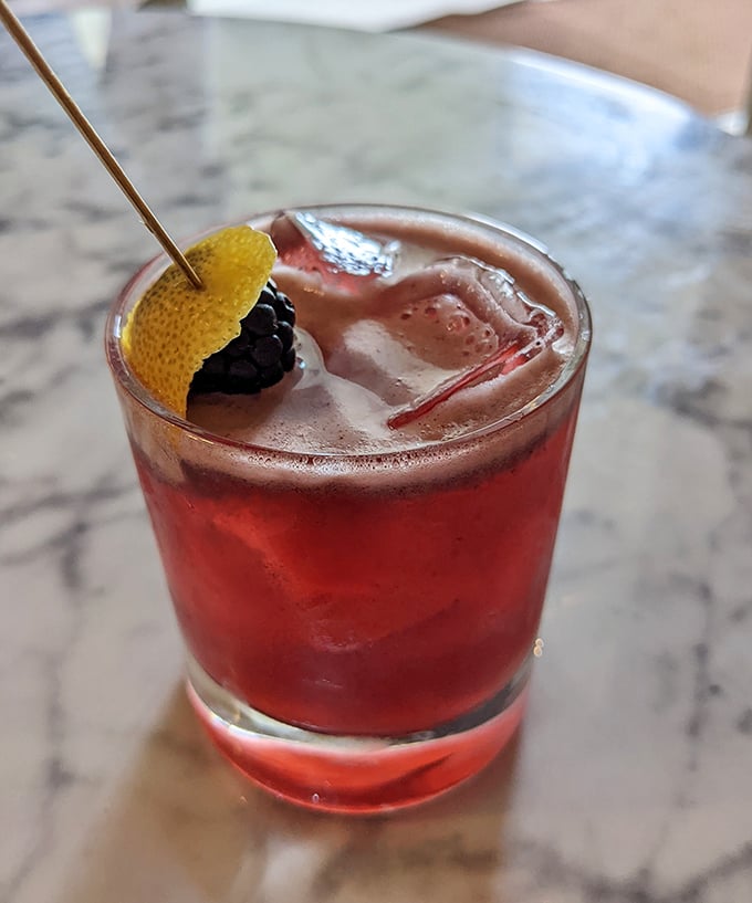 This crimson cocktail, garnished with blackberry and lemon, isn't just Instagram-worthy—it's a sophisticated adult reward for surviving another Michigan winter.
