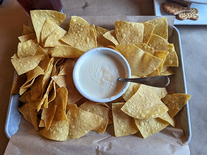 These aren't just tortilla chips—they're crispy vehicles engineered specifically for maximum queso transportation efficiency.