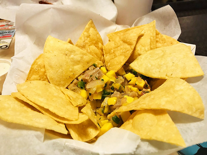 Tortilla chips surrounding fresh ceviche like eager beachgoers around a tidal pool—ready to dive into those bright, zesty flavors.