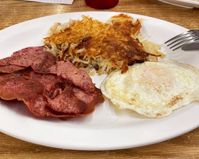 The holy trinity of breakfast: crispy hash browns, savory ham, and a perfectly cooked egg. Some mornings don't need innovation, just perfection.