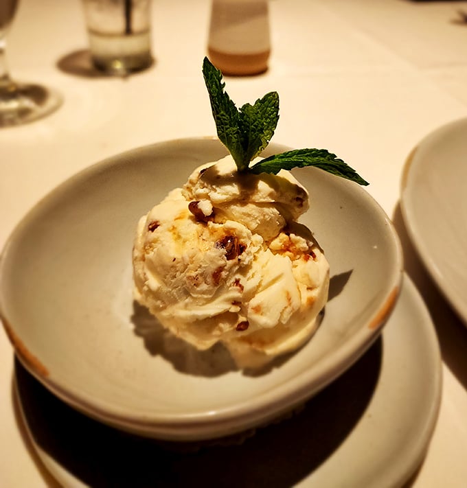 Ice cream that doesn't need pyrotechnics or Instagram filters—just pure, creamy perfection topped with a mint leaf crown.