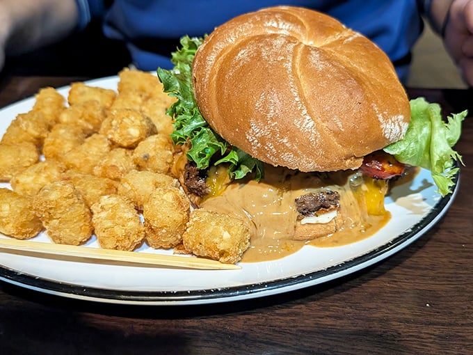 Not just a burger—a commitment. Those tater tots are the unsung heroes, waiting patiently for their moment in the spotlight.