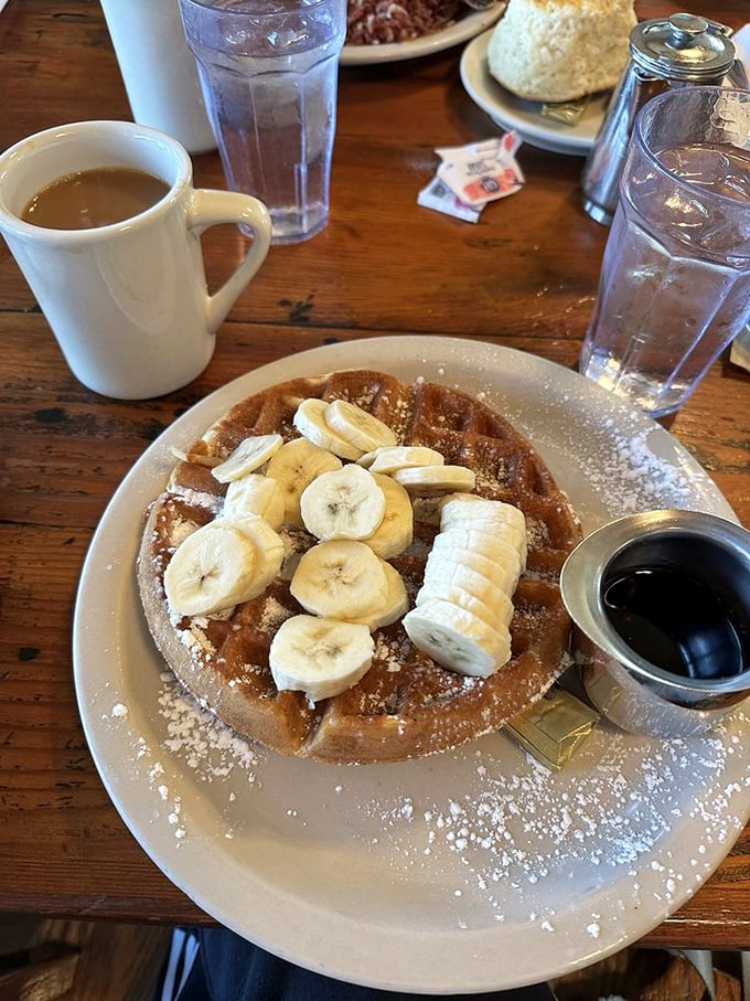 A waffle topped with fresh bananas—proof that sometimes the simplest combinations are culinary masterpieces. Morning sunshine on a plate.