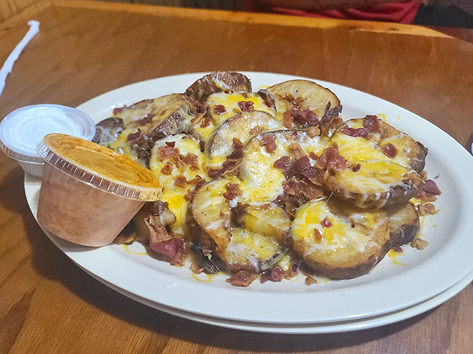 Potato wedges living their best life under a blanket of melted cheese and bacon—proof that sometimes the side dish steals the spotlight.