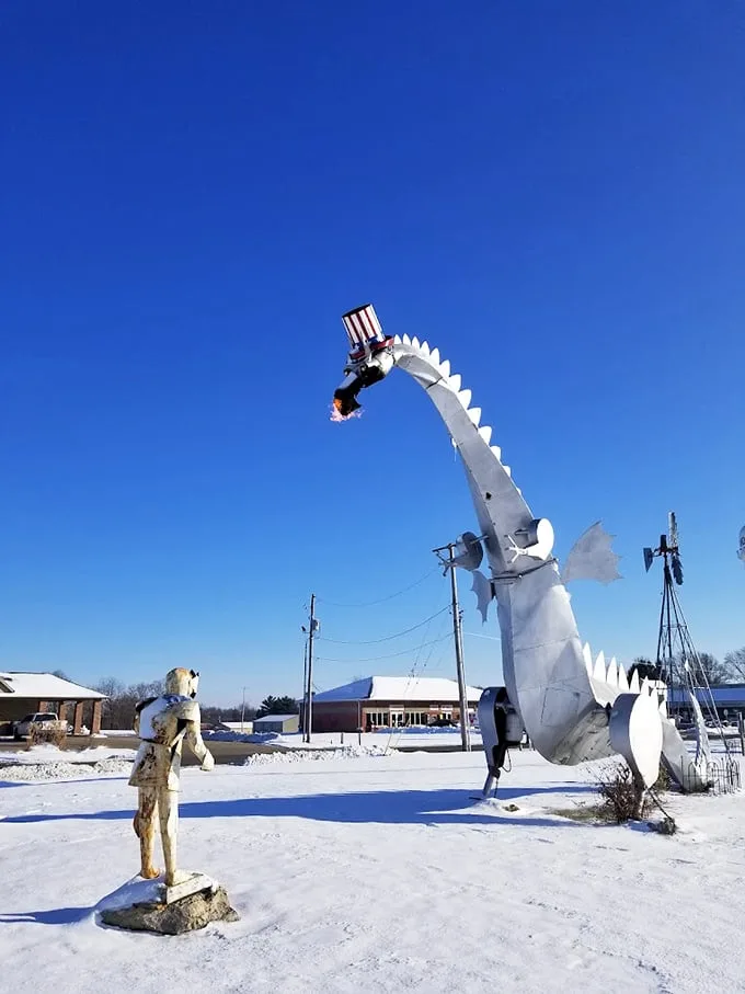 Even in winter's embrace, the dragon and knight maintain their eternal standoff, now surrounded by a blanket of snow.