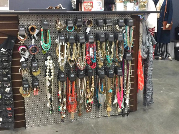 The accessories wall – where statement necklaces and colorful baubles hang like trophies, waiting to transform basic outfits into fashion statements.