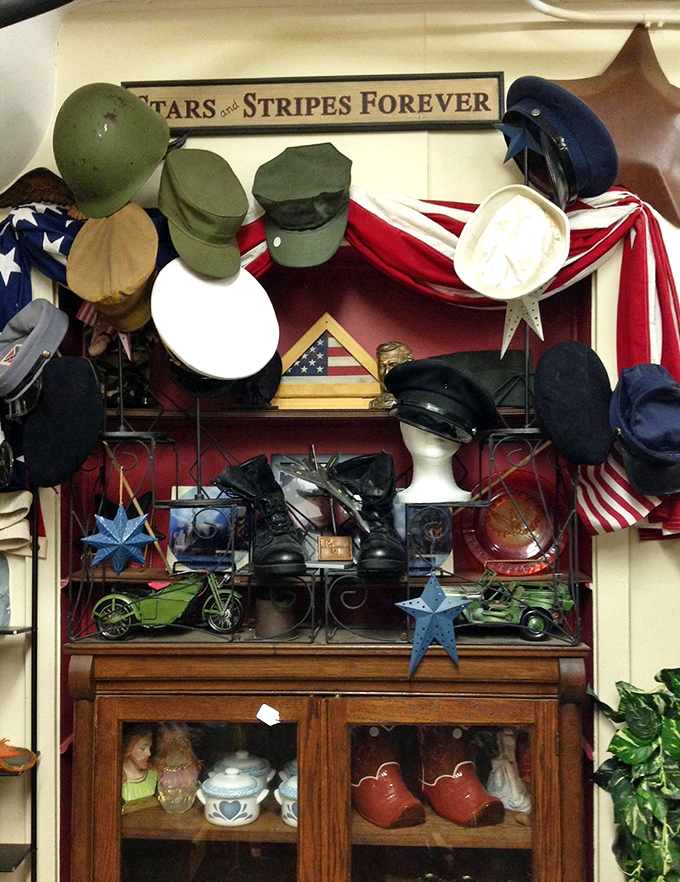 Military memorabilia shares space with American flags—a patriotic corner that honors service while preserving pieces of our national story.