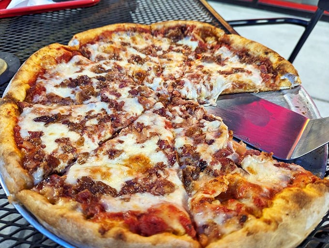 Meat lover's pizza that doesn't whisper its intentions—it announces them with a chorus of perfectly crisped bacon atop that beautiful cheese canvas.