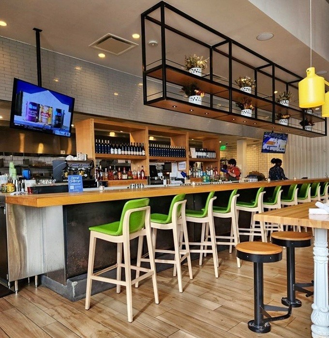 The bar area invites you to perch on those cheerful green stools and sip something that's both virtuous and delicious—a rare combination indeed.