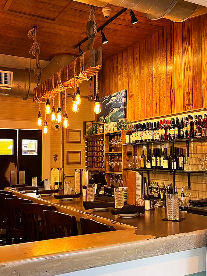 The bar doesn't just serve drinks—it serves atmosphere. Those Edison bulbs dangling from nautical rope weren't just designed; they were curated.
