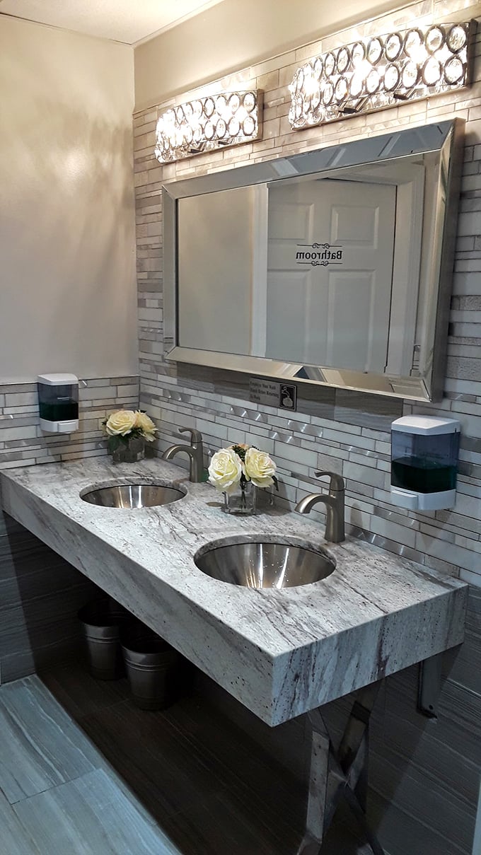 Even the restroom gets the royal treatment with elegant lighting, marble countertops, and fresh flowers—unexpected luxury in a family restaurant.