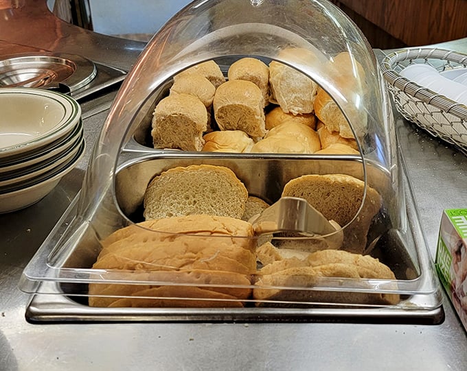 Fresh-baked bread awaits beneath a protective dome, promising that your meal will begin with that most sacred of Midwestern traditions—carbs done right.
