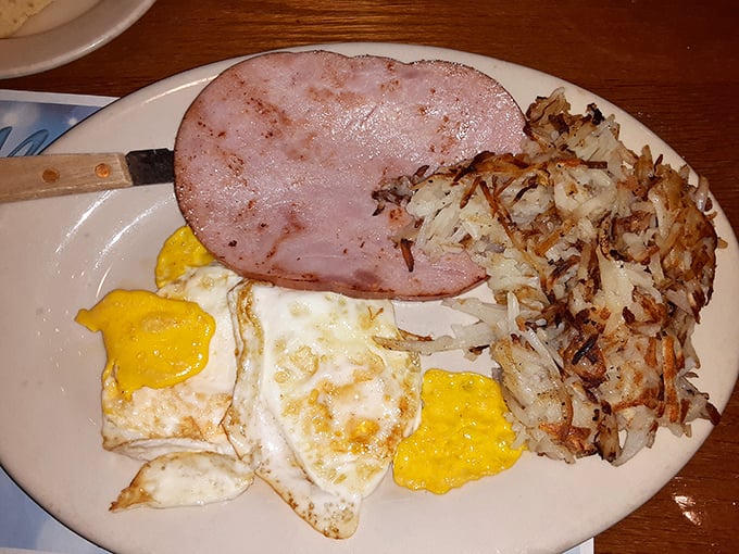 The breakfast trinity: perfectly fried eggs, crispy hash browns, and bacon that would make vegetarians reconsider their life choices. 