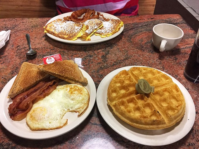 Three distinct breakfast personalities sharing one table—the disciplined toast-and-eggs, the indulgent French toast, and the magnificent Belgian waffle.