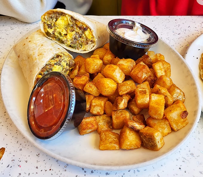 A breakfast burrito flanked by home fries so perfectly golden they deserve their own Instagram account.