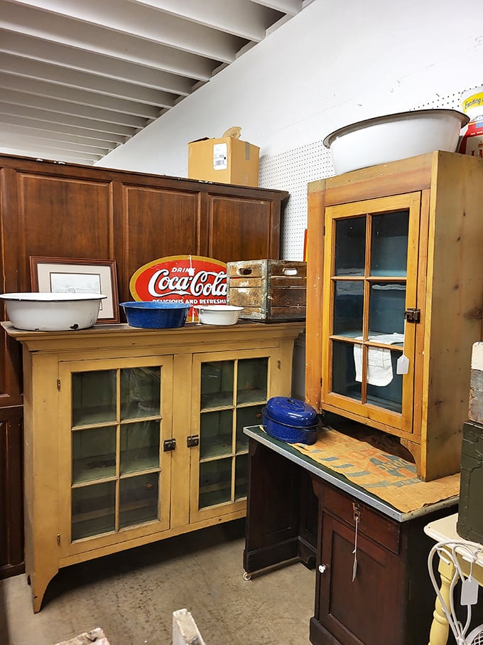 These vintage cabinets with their original glass panes have witnessed decades of family dinners. That Coca-Cola sign adds the perfect nostalgic touch.