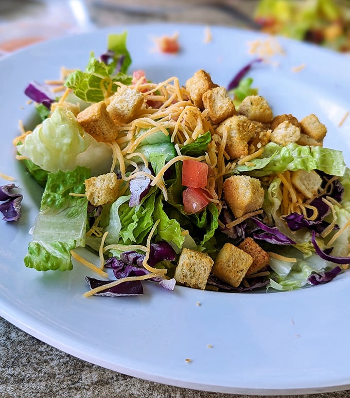 A salad that knows its role – fresh, crisp, and colorful, providing the perfect intermission between acts of seafood indulgence.