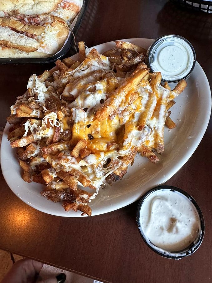 Cheese fries elevated to an art form. That melty blanket covering hand-cut potatoes isn't just a side dish—it's what dreams are made of.